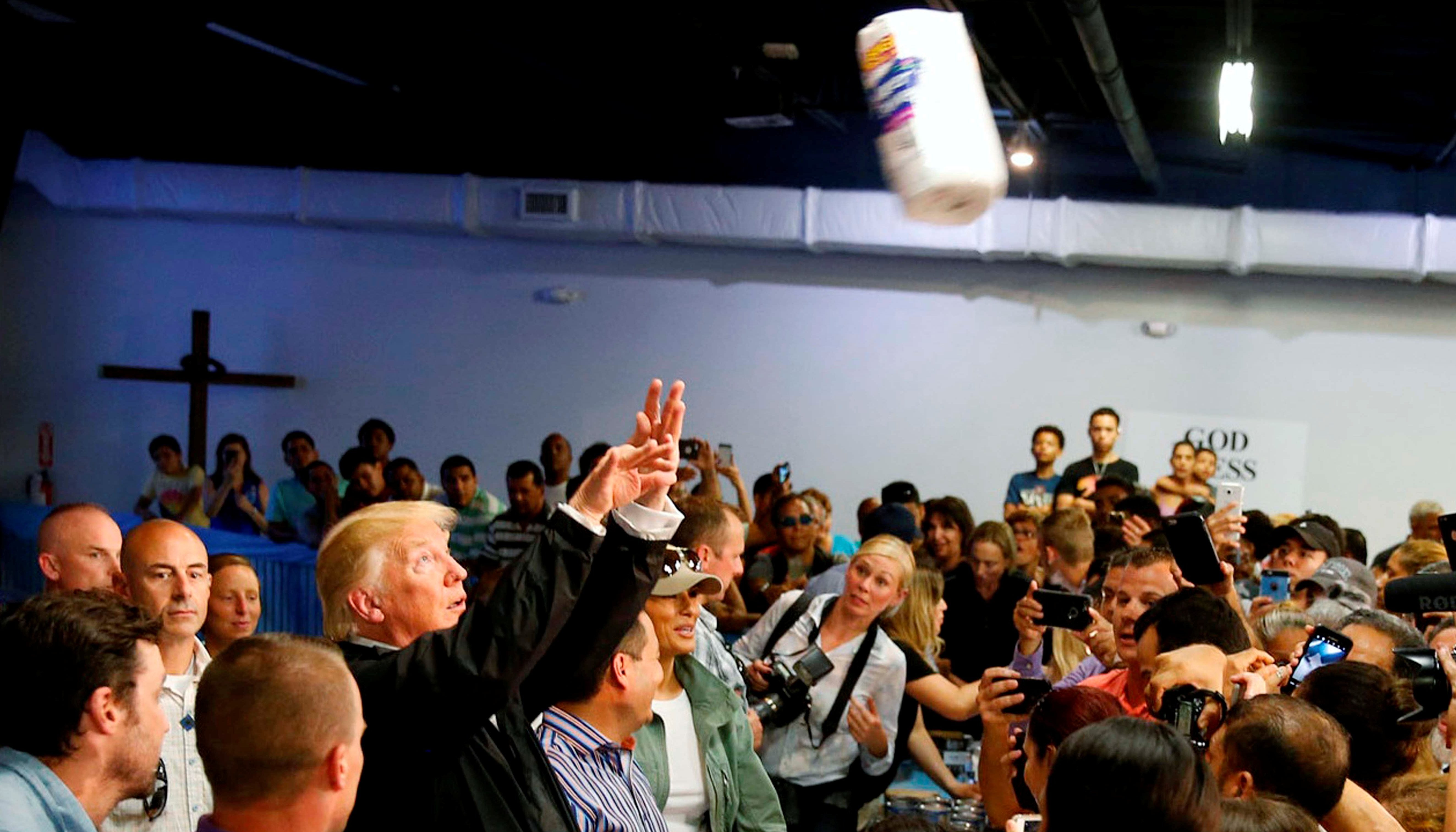 Pictures of Donald Trump throwing paper towel rolls at Puerto Ricans